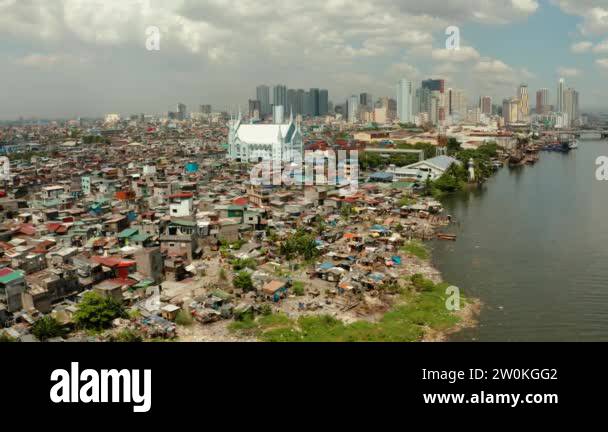 Slums of poor people on the background of a big city. The city of ...