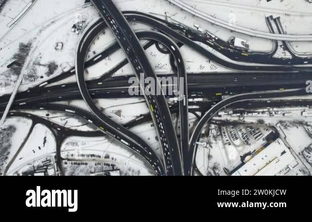 Cars driving on road interchange at winter. Top view snowy highway intersection Stock Video ...