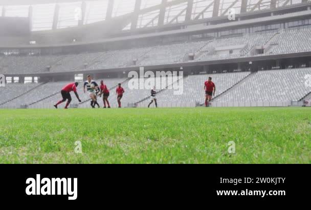 Front view of diverse rugby players playing rugby match in stadium ...