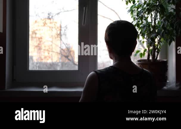 Back view of grandmother looking out window. Concept. Elderly woman ...
