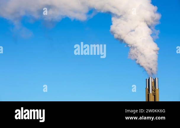 White smoke rising from smokestacks into the blue sky. Conceptual video ...
