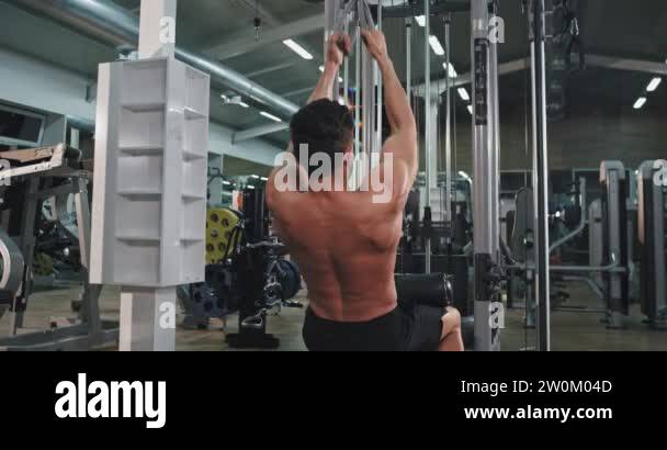 Modern gym class young guy doing hard workout for his biceps and ...