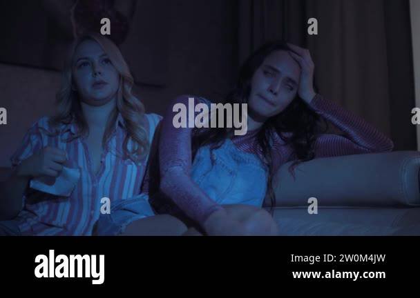 Two young beautiful sad girls are watching a sad melodrama Stock Video ...
