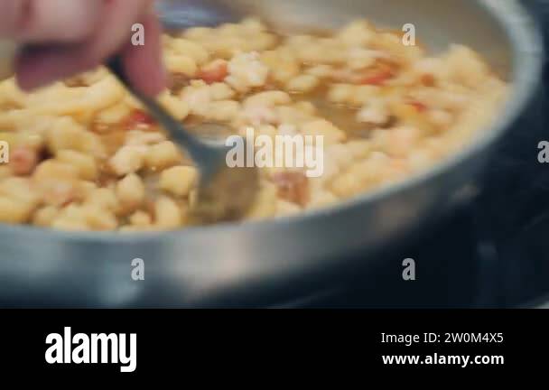 Pasta's cooking in the frying pan. Someone is cooking pasta. Food video ...