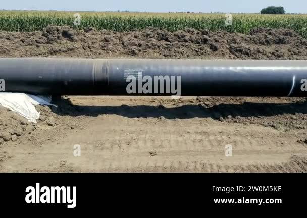 Oil and Gas Pipeline - Aerial Drone Panning Shot. Pipes are laid on top ...