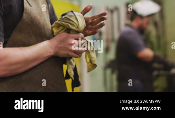 Mid section of a Caucasian male factory worker at a factory making ...
