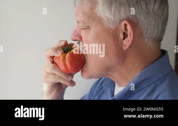Biting into a tomato Stock Videos & Footage - HD and 4K Video Clips - Alamy