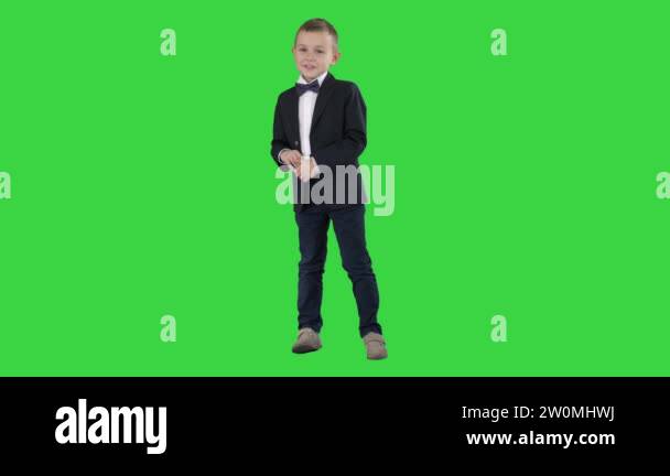 Little boy in formal outfit talking and smiling on a Green Screen ...