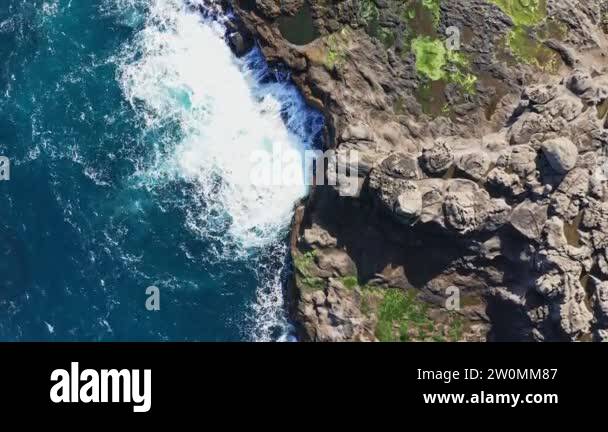 Wild Shoreline aerial view.Overhead aerial view of ocean waves crashing ...