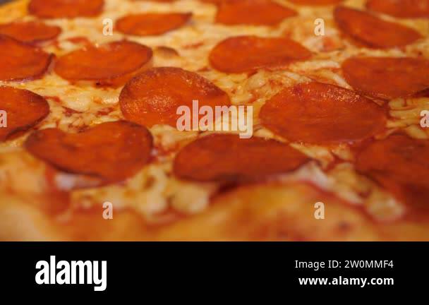 Pepperoni pizza rotates close-up. Delicious footage for the menu of ...