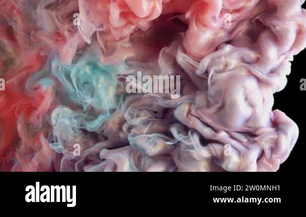 Colorful blue/red paint drops from left mixing in water. Ink swirling ...