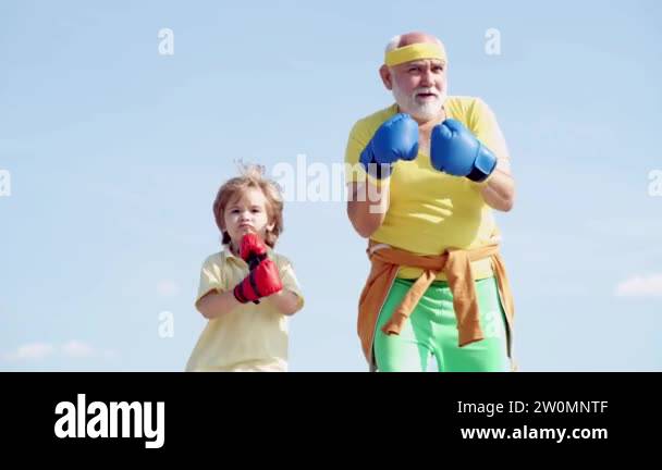 Healthy fighter Grandfather and grandson with boxing gloves ...