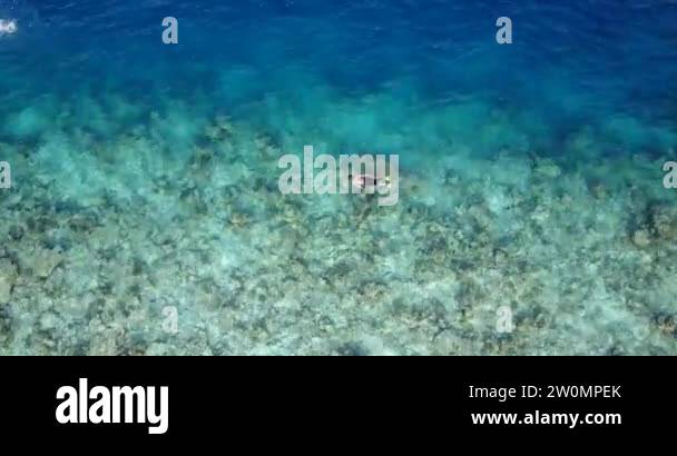 Young man swimming and snorkeling on turquoise crystal clear water of ...