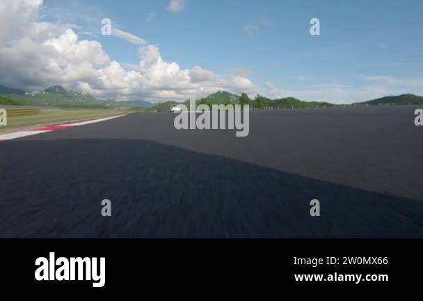 POV: Speeding through the curves of a cool asphalt racetrack during an ...