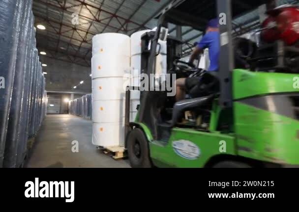 Forklift in a warehouse of synthetic materials. A forklift rides ...