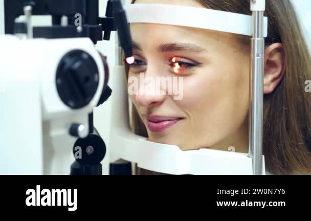 Face of a young female at an ophthalmologist office. Smiling woman ...