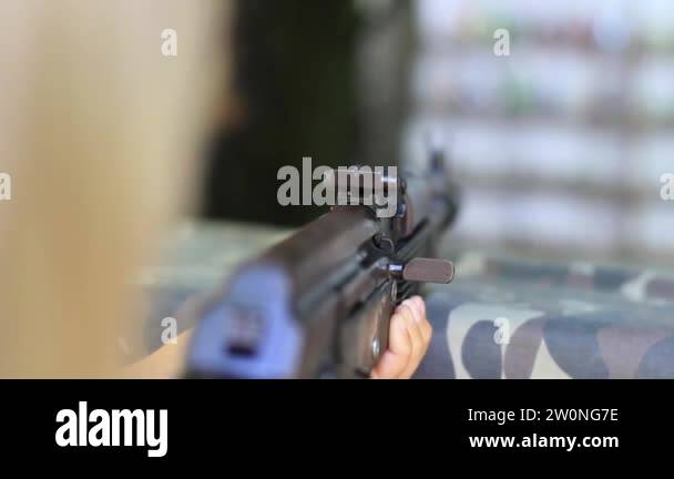 female hand is aiming at the front sight. Shooting with a machine gun ...