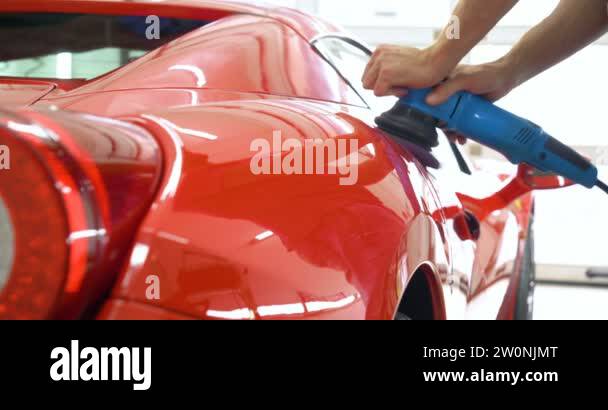In the car center (in the garage), professionals polish a new sports ...