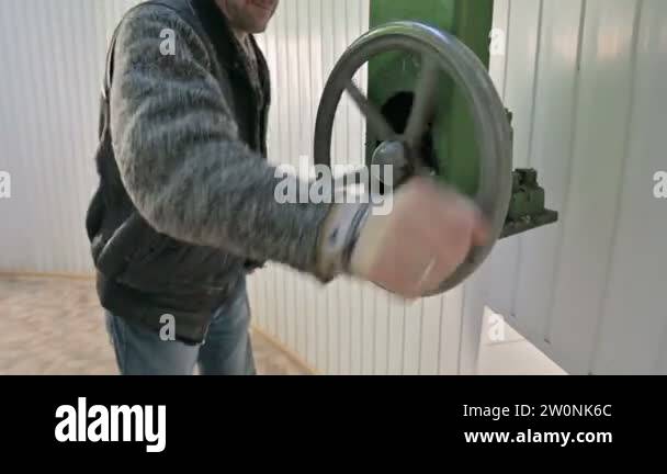 A male researcher rotates the manual wheel of the opening mechanism of ...