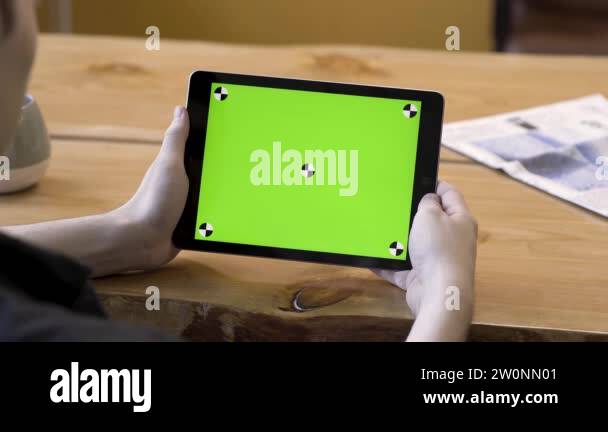 Young guy holding the tablet with touching green screen with tracking ...