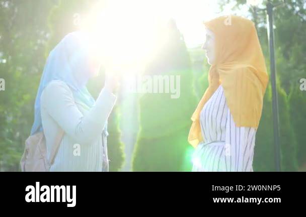 Two young hard of hearing muslim women in traditional scarves and ...