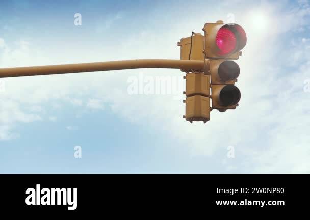 A Traffic Light Changing from Red to Green with Blue Sky and the Sun as ...
