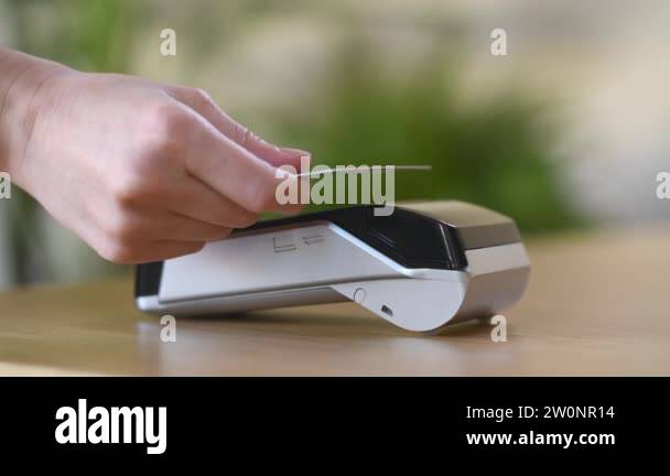 Close up hands of woman making payment with credit card machine ...