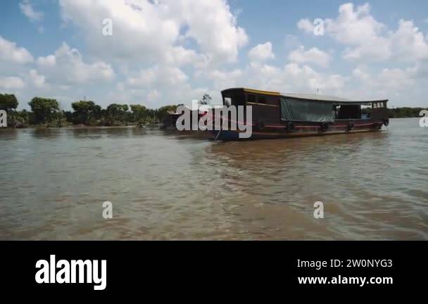 Traditional Vietnamese ferry boat taking people and their bicycles ...
