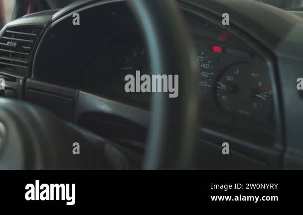 checking the engine speed on the instrument panel with a tachometer ...