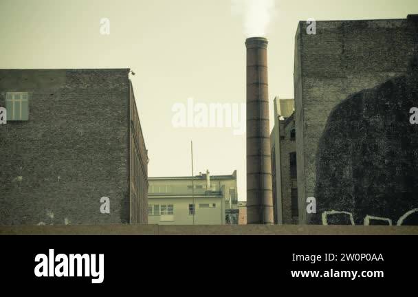 Cinemagraph of smoke emitted from an industrial brick chimney in an old ...
