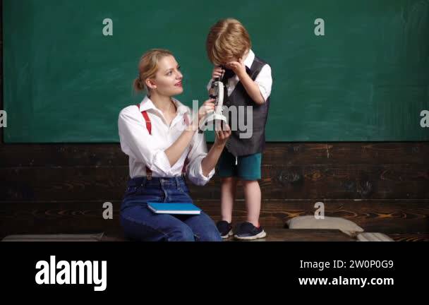 Elementary school teacher and student in classroom. Back to school ...