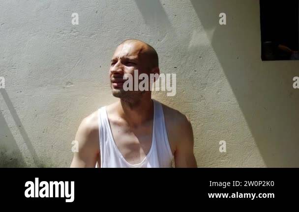 Young skinny anorexic drug addict and mental ill homeless man sitting ...