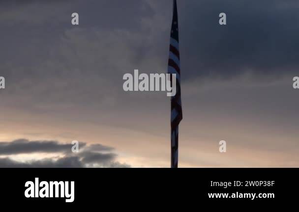 american flag waving at the top of a tall flag pole Stock Video Footage ...