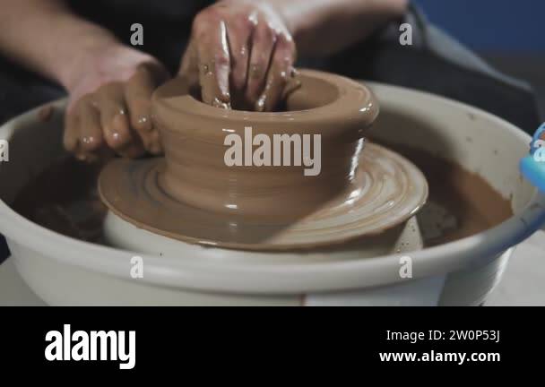 Man works with potter's wheel and clay. Ceramics of handwork and clay ...
