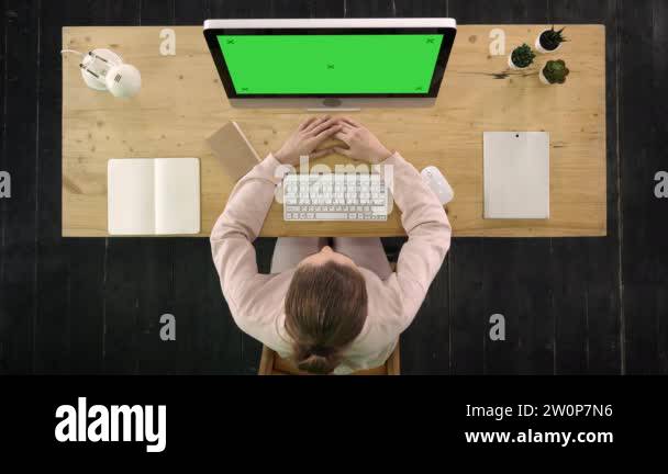 Young woman looking on the monitor of computer. Green Screen Mock-up ...
