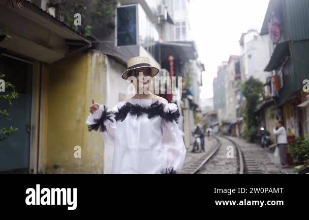 Beautiful and young fashion mestizo girl walking along the asian street ...