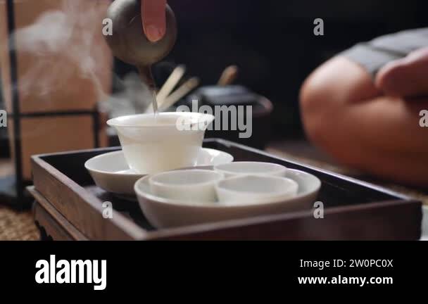 Traditional Chinese gongfu or kung fu tea ceremony. Tea master pours ...