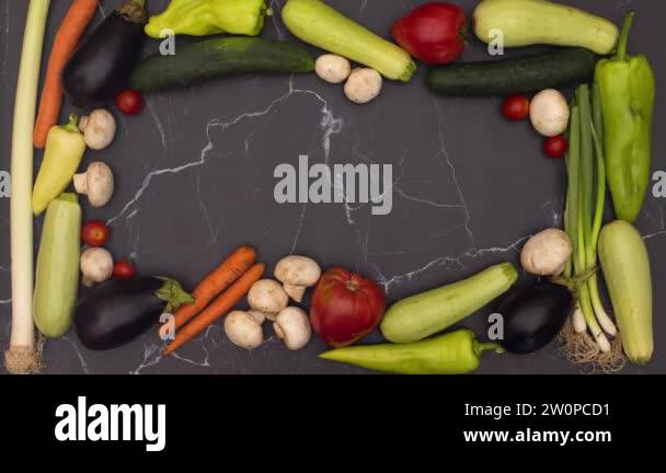 Stop motion animation of fresh vegetables making frame and leave empty ...