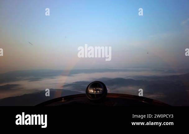 Flying above fog covered landscape, pilots perspective from the cockpit ...