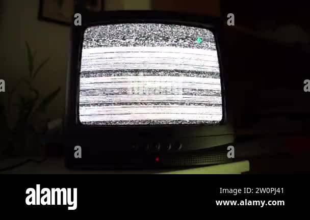 Old vintage TV transmission in dark room, flicking retro TV screen with ...