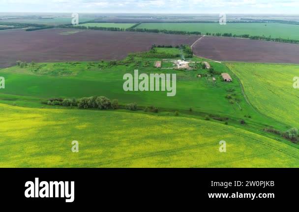 Drone aerial establishing shot of a classic farmhouse farm and barns in ...