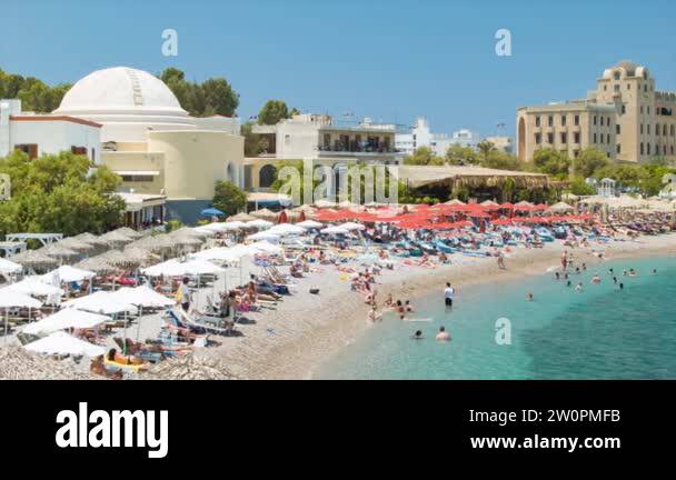 People Enjoying Eli Beach in Rhodes Greece Sunbathing with Umbrellas at ...