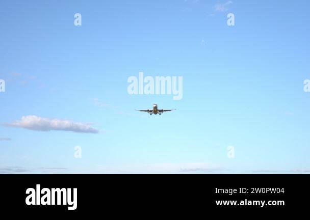 Modern passenger plane flies overhead, exactly in the center of the ...