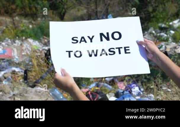 Say no to waste phrase on cardboard in hands against landfill ...
