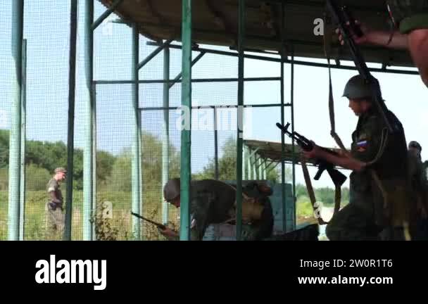 MOSCOW - JULY 30. Soldiers shoot from an AK-47 machine gun at targets ...