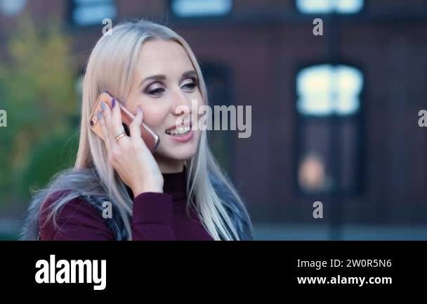 Smiling professional woman making a friendly phone call, could be ...