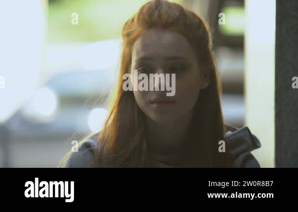 Upset redhead teenager girl crying outdoor, suffering loneliness and depression Stock Video ...