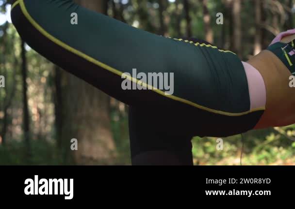 Fit girl doing hip exercises in the park. Donkey kick exercise for ...