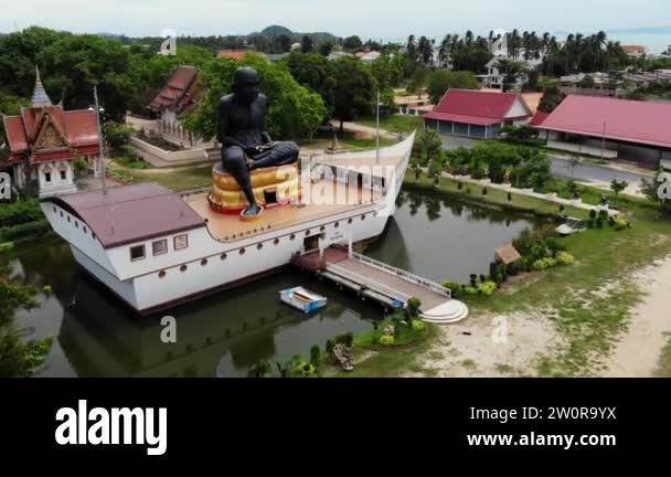 Black monk statue on ship in pond. Huge black monk sculpture located in ...