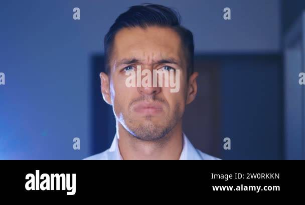 Portrait of attractive man making facepalming pose with hand. Showing ...